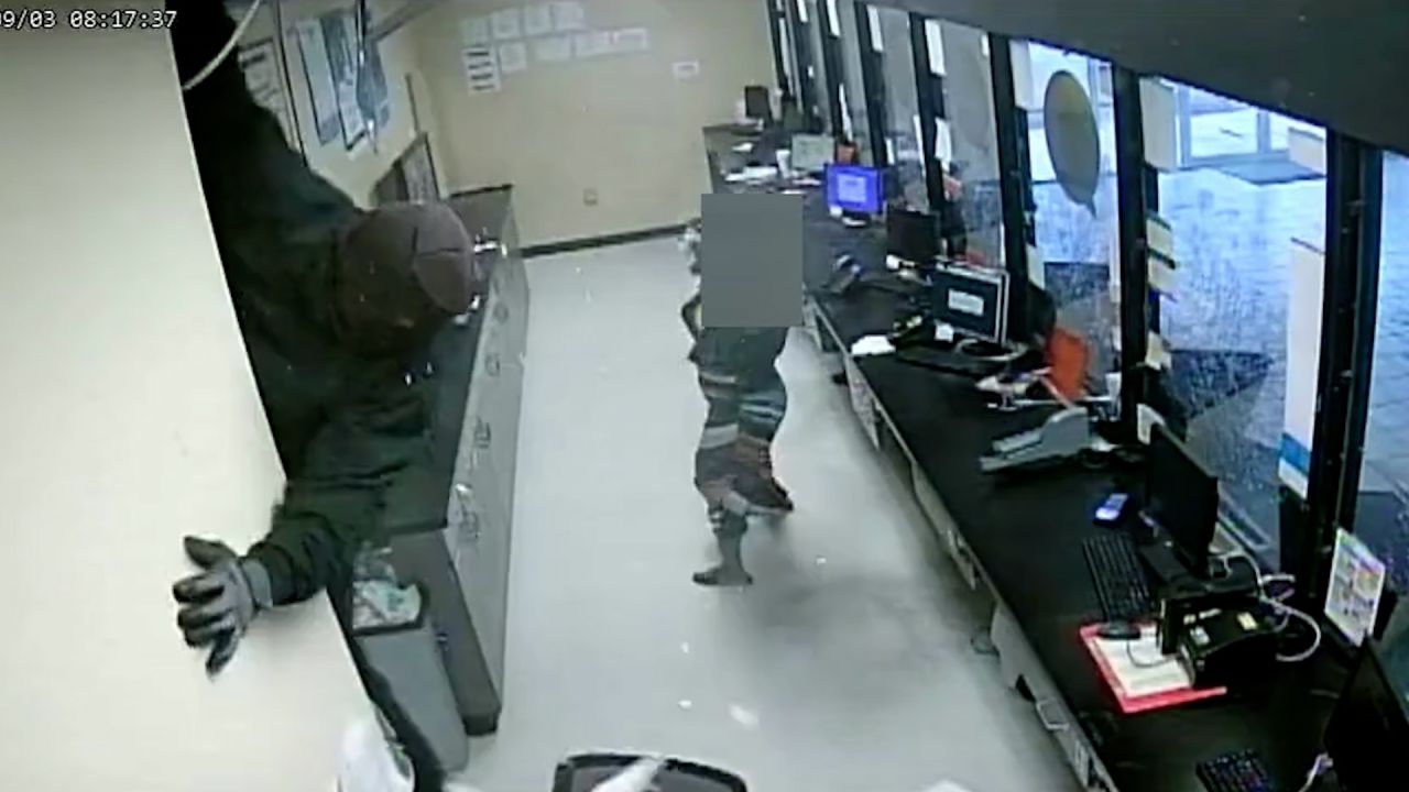 Video: Masked men crash through ceiling during robbery | CNN