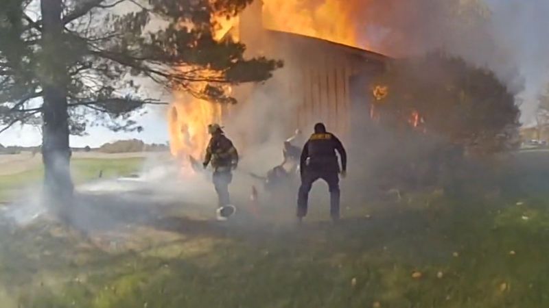 Bodycam captures rescue of woman trapped in basement of her burning house | CNN